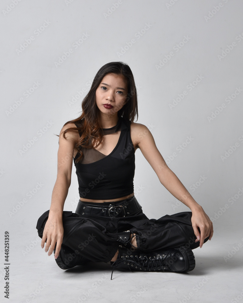Full length portrait of pretty young asian girl wearing black tank top ...