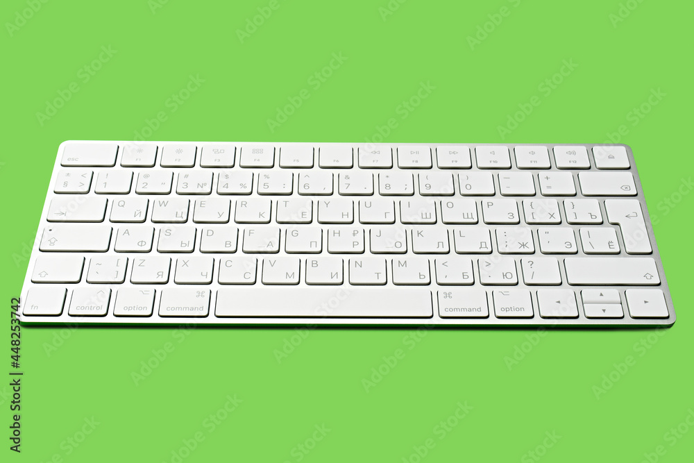 Keyboard White wireless computer keyboard isolated on green background ...