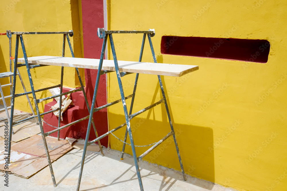 Scaffolding in the ground used to repaint the exterior walls of a house ...