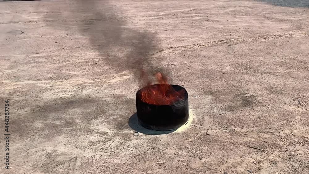 Extinguishing the oil in the tin burned for the fire drill with a fire ...