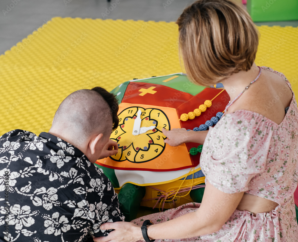 Children with disability getting sensory activity with toys, balls ...