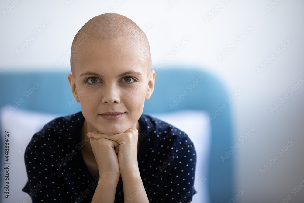 Foto de Head shot happy young hairless woman putting head on folded ...
