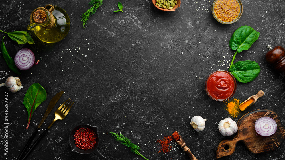 Black stone cooking background. Spices and vegetables. Top view. Free ...