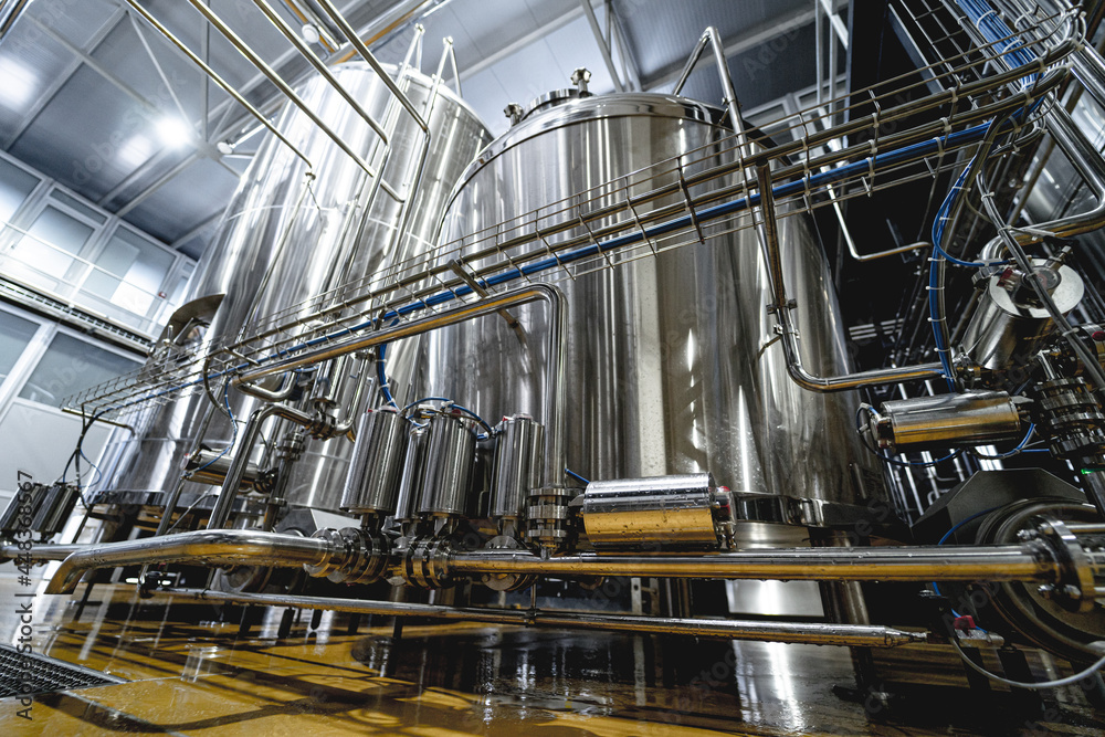 Rows of steel tanks for beer fermentation and maturation in a craft ...