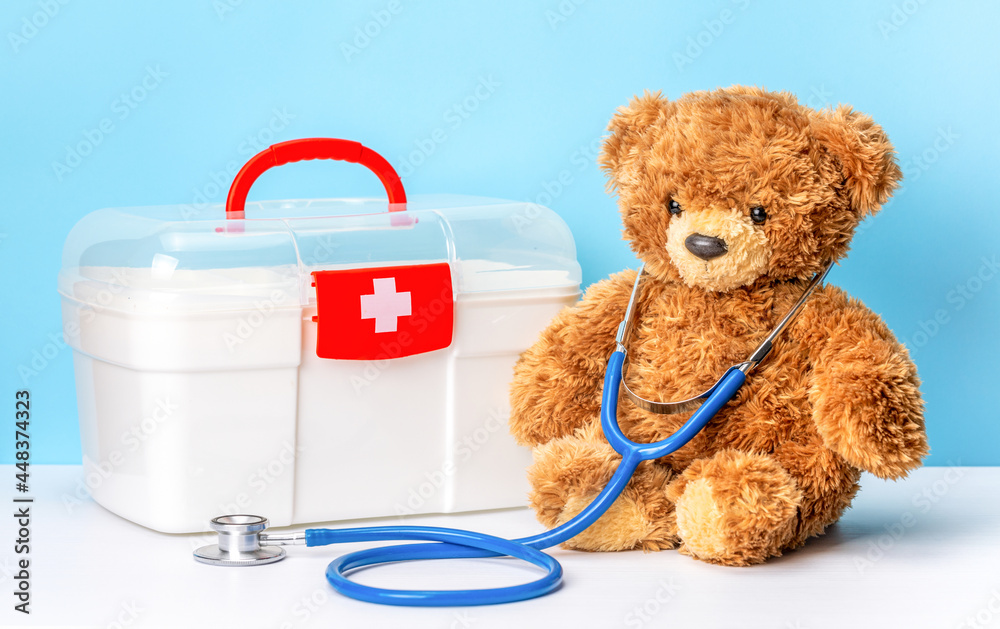 Pediatrician or family doctor concept. Teddy bear with stethoscope and ...