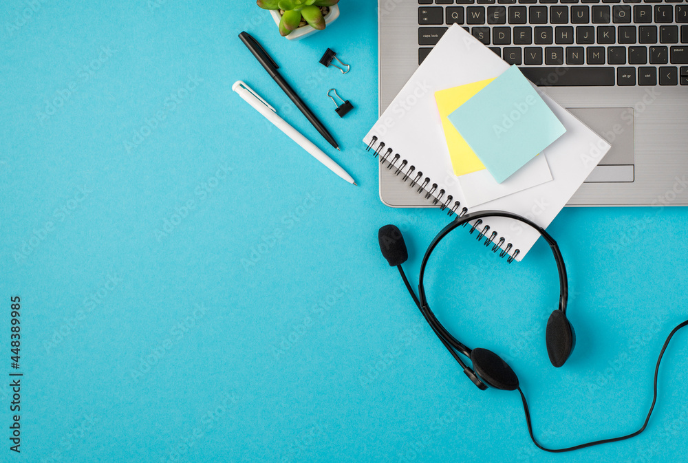 Top view photo of laptop wired headset with microphone plant binder ...