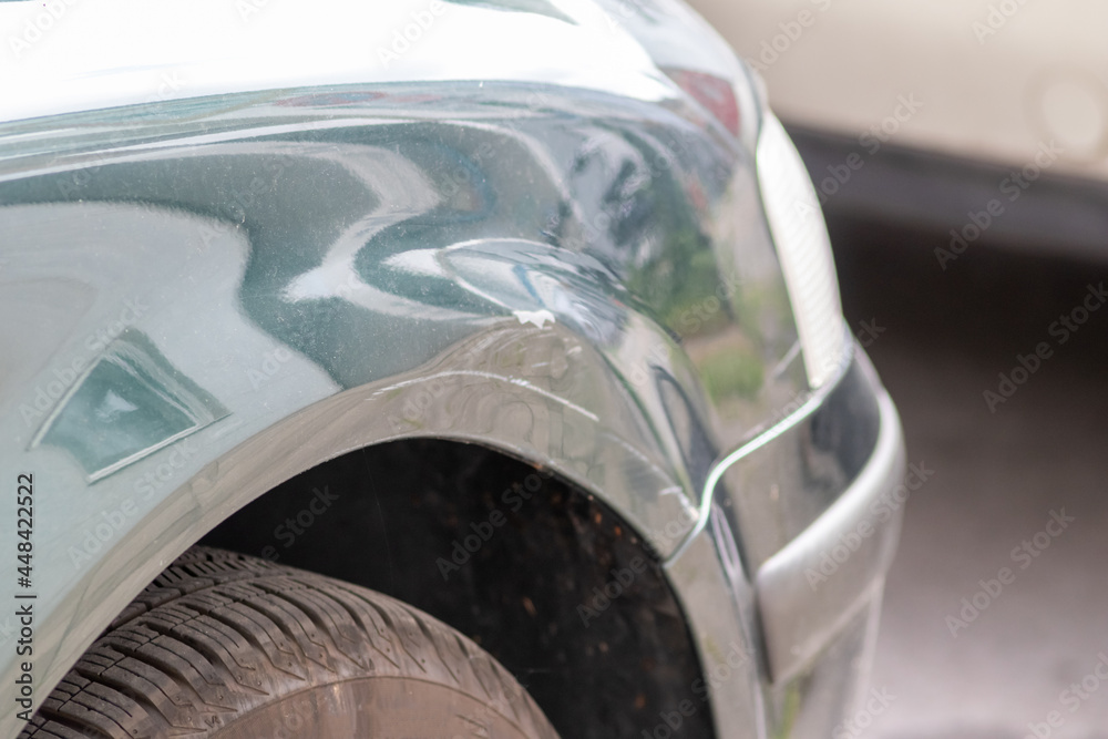 Dented car wing and fender with scratches and bumps after crash and car ...