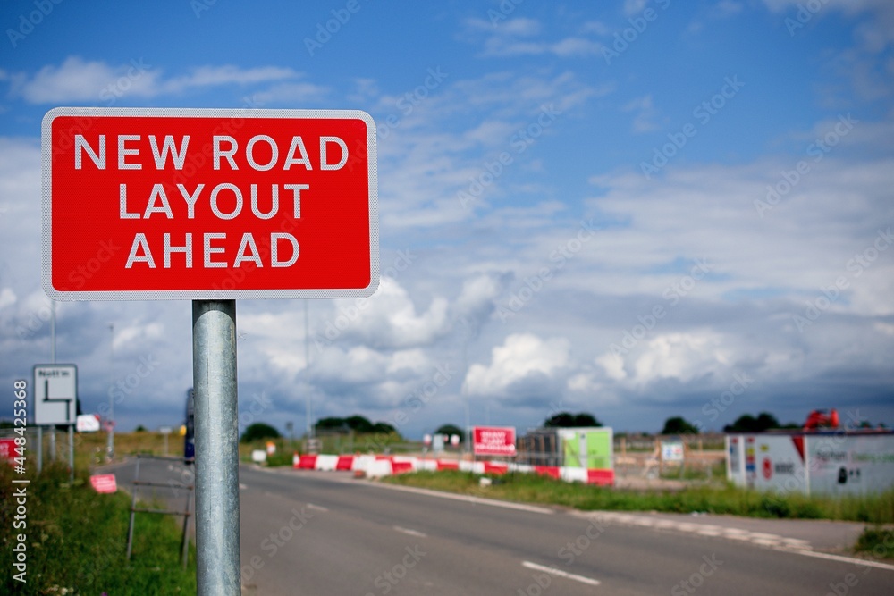 UK Road signs New Road Layout Ahead against a blue cloudy sky. Stock ...
