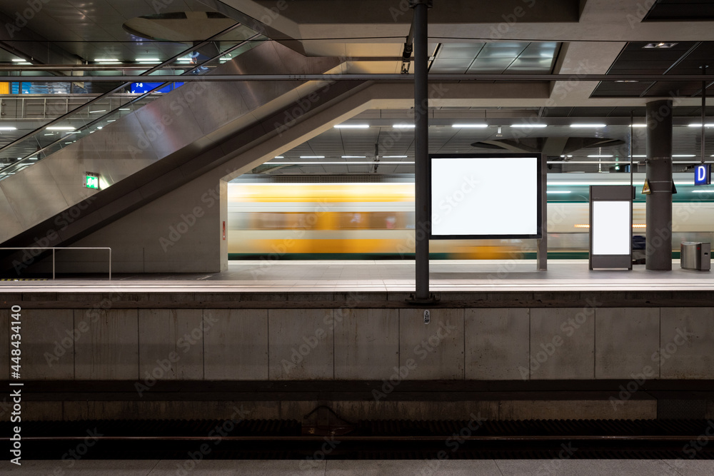 Interior view of platform railway station with escalator and motion of ...