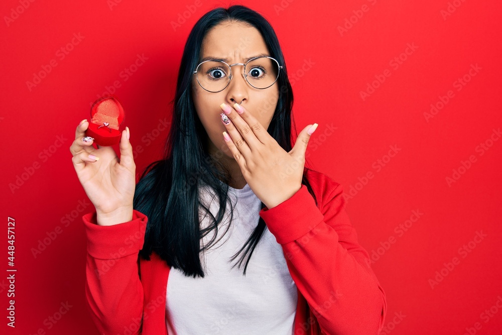 Beautiful hispanic woman with nose piercing holding engagement ring for ...