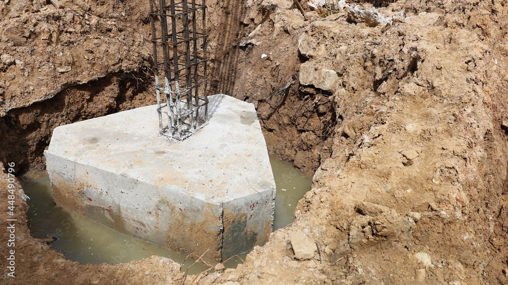 Pier base and steel frame. Concrete poles of houses or buildings in a ...