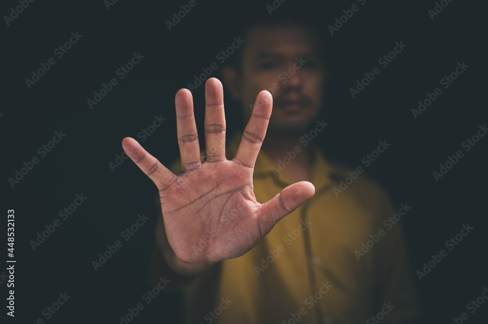 Man hand stop sign, male showing hand for stop gesture. dark tone ...