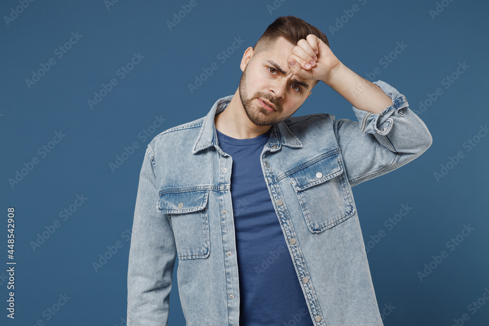Tired fatigued sad frowning young brunet man 20s wears denim jacket ...