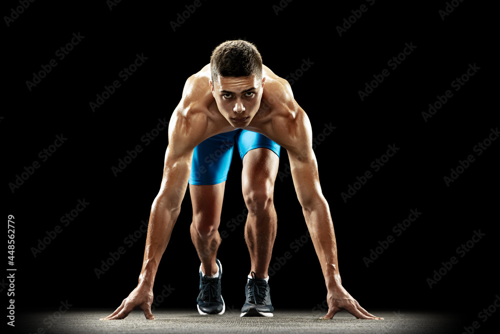 Winner. Portrait of young professional male athlete, runner isolated on ...