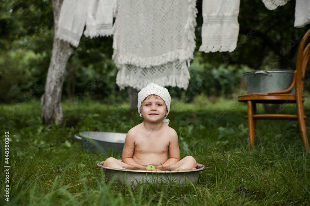 Three-year-old baby without clothes in basin in village garden Stock ...