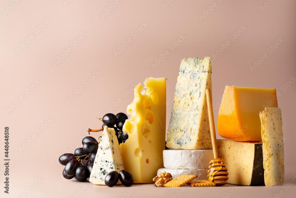 Different types of cheese on pastel pink light background. Cheeses mix ...
