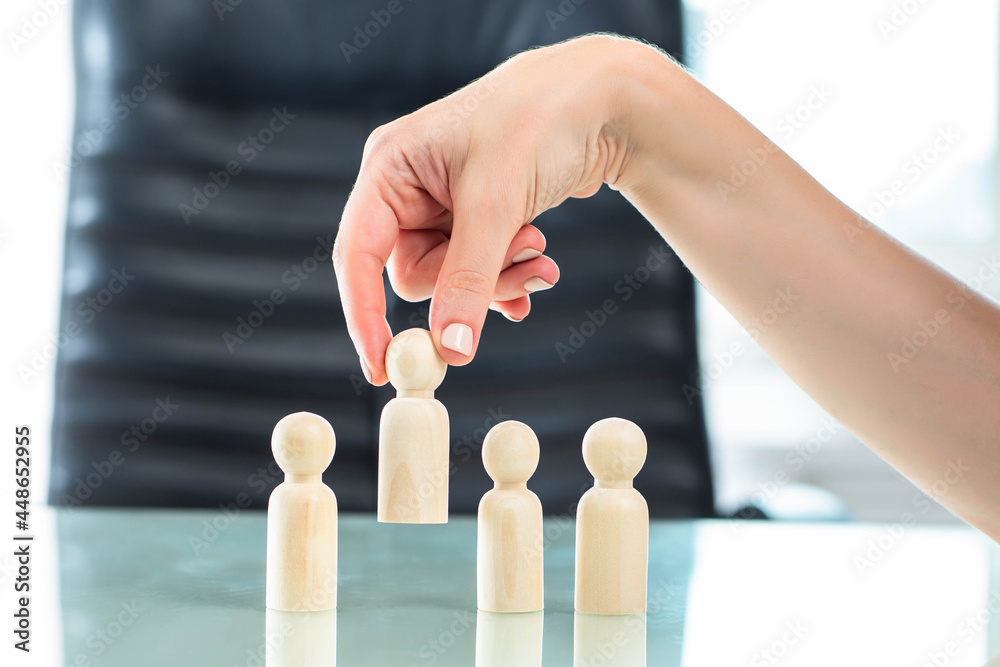 Recruiting and selection candidates. Little wooden men recruiter desk ...