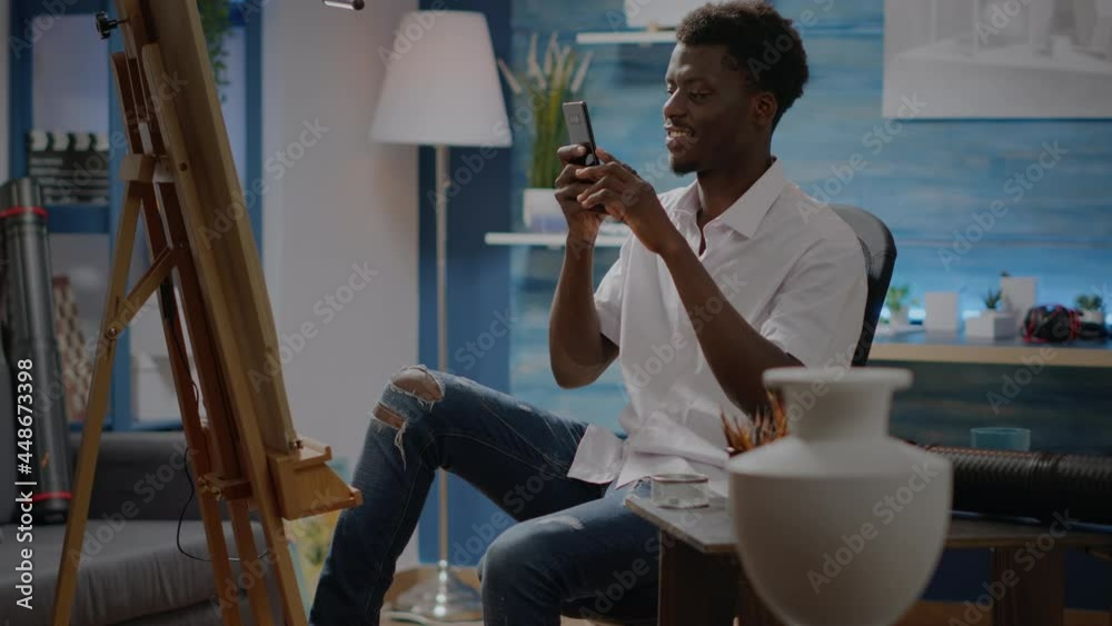 Black drawing artist using smartphone for fine art pictures in artistic ...