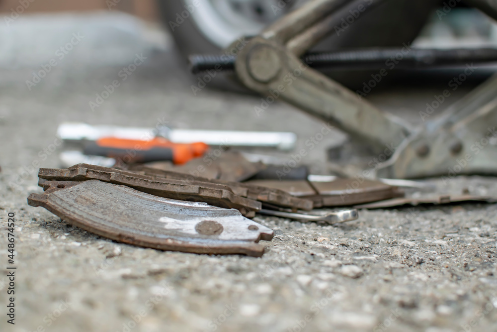 worn out, old, rusty car brake pads, worn to iron, lie on the ground ...