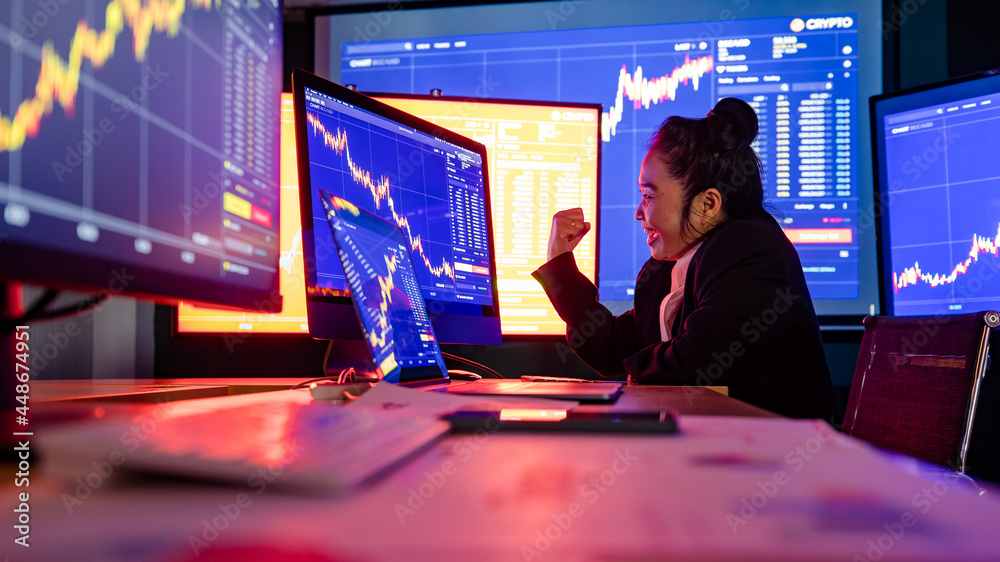 Happy successful female professional broker trader investor sit smile show victory sign fist up ...