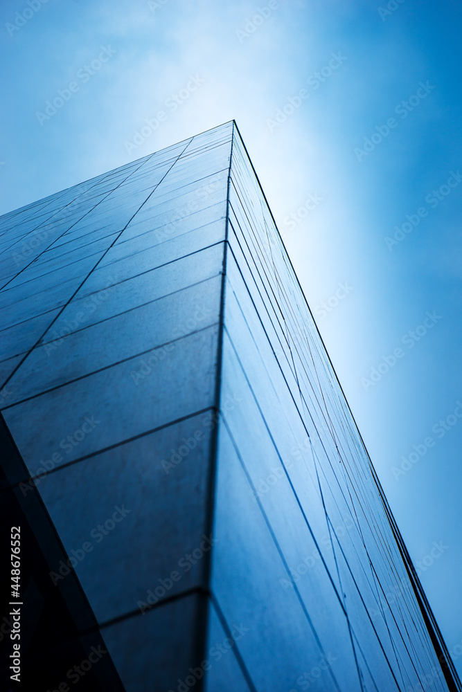 Looking up at the city’s tall buildings from a low angle, the side of ...