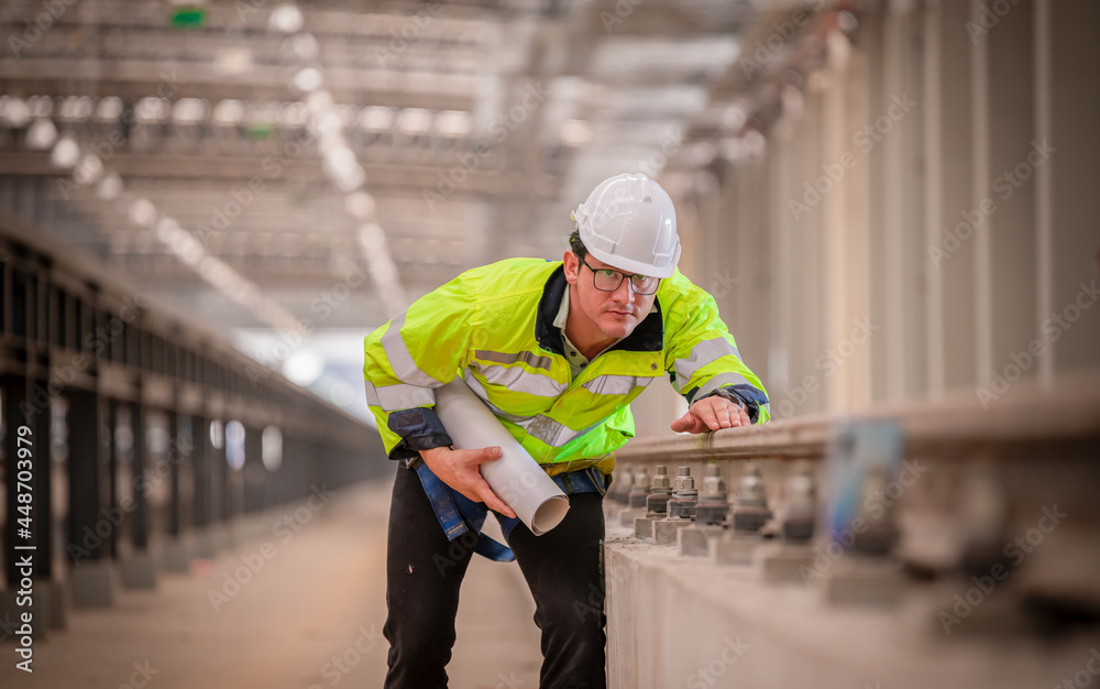 Engineer under inspection and checking construction process railway ...