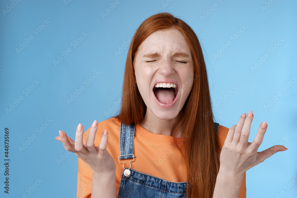 Pissed outraged moody redhead girl shouting complaining angry standing ...
