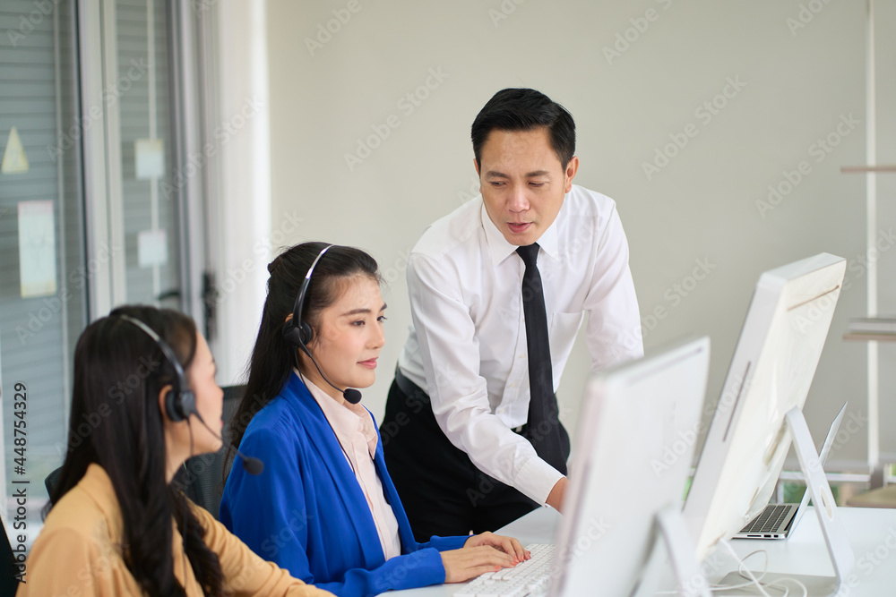 Teamwork of call center team concept , manager coaching female call ...