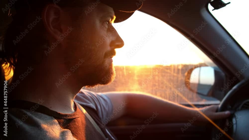 Man Driving a Car at Sunset. Male Hand on steering wheel close up ...