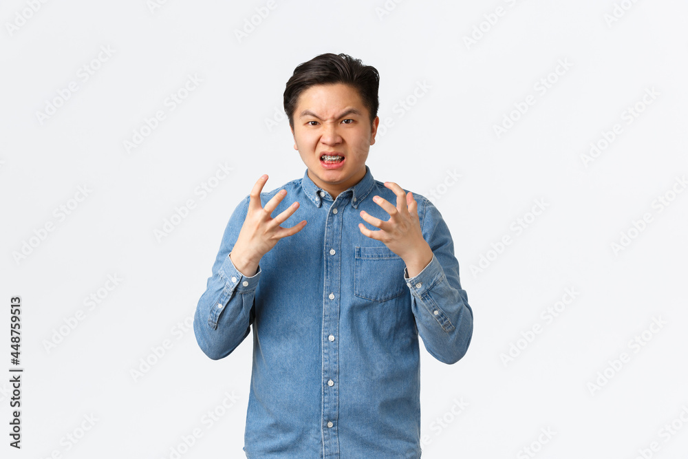 Outraged aggressive and pissed-off asian man shaking hands frustrated ...
