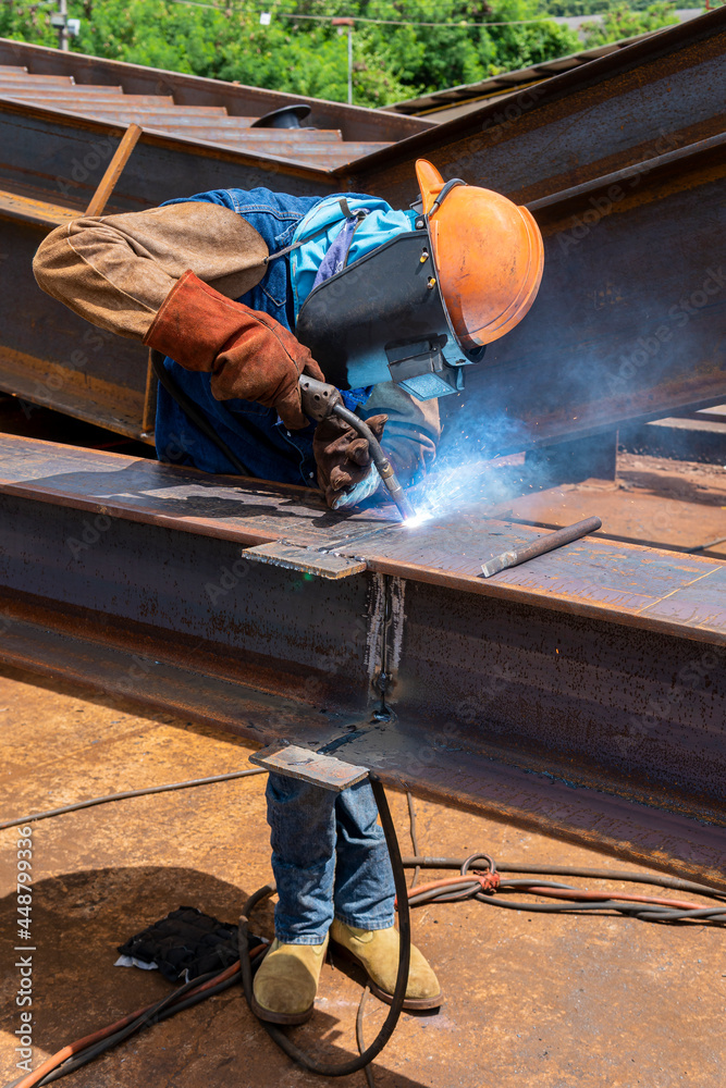 Welder is welding add joint h-beam for steel structure work with ...