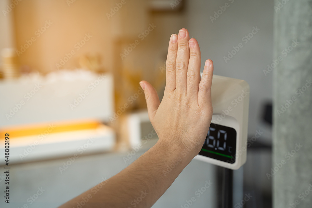 Women hand checking temperature before entering cafe with digital ...