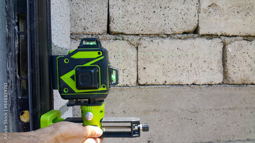 Laser level gauge for measuring green light on a construction site for ...