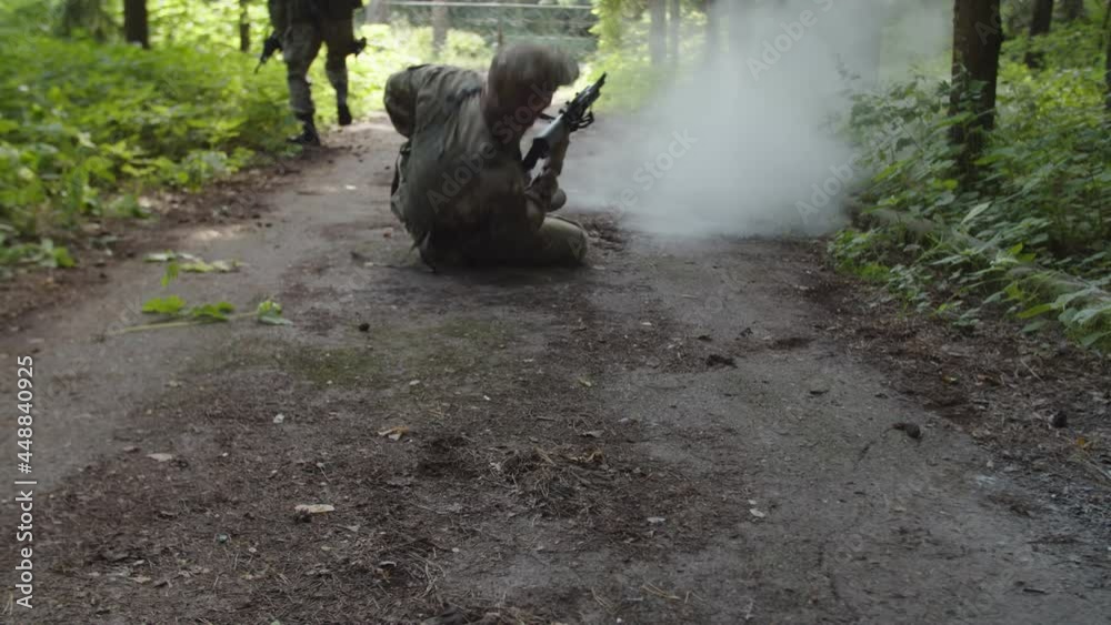 Equipped soldiers in camouflage getting ambushed with explosion enemy ...