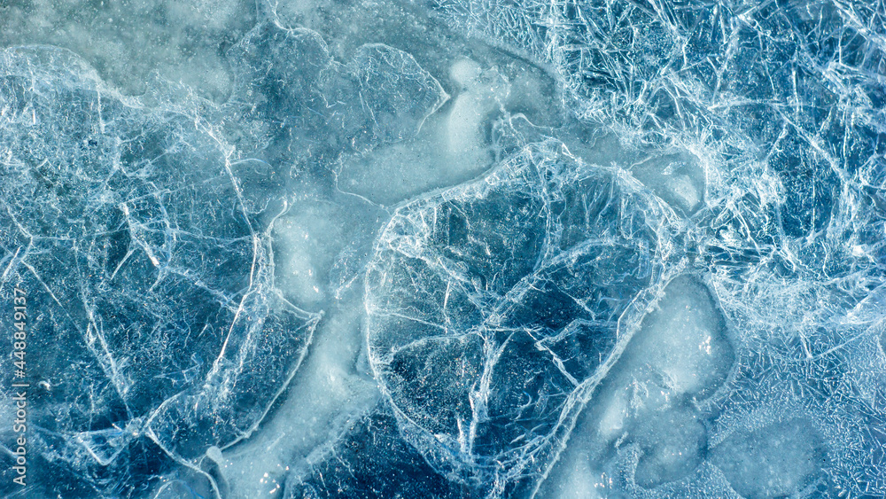 Beautiful ice texture with cracks of a frozen puddle on the asphalt for ...