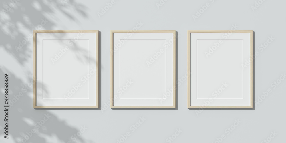 Three wooden frames on white wall. Triptych. 3D render wooden frame mock up. Empty interior. 3D ...