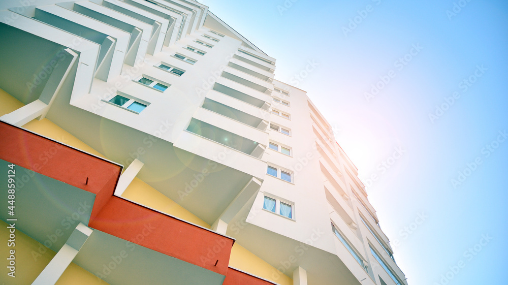 Modern white facade of a residential building with large windows. View ...