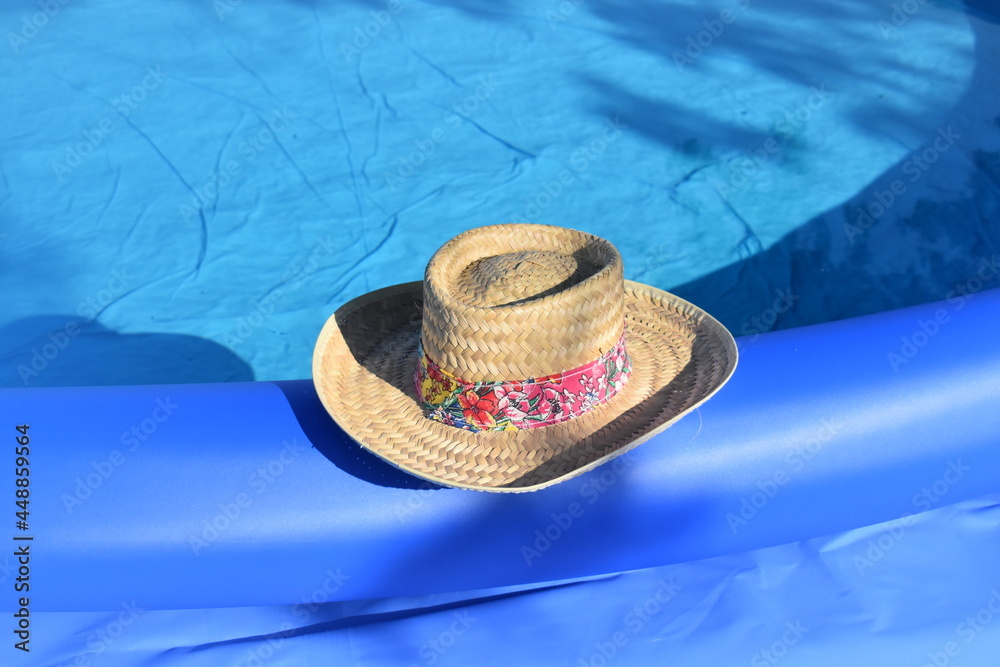 Straw Hat by a Swimming Pool Stock Photo | Adobe Stock