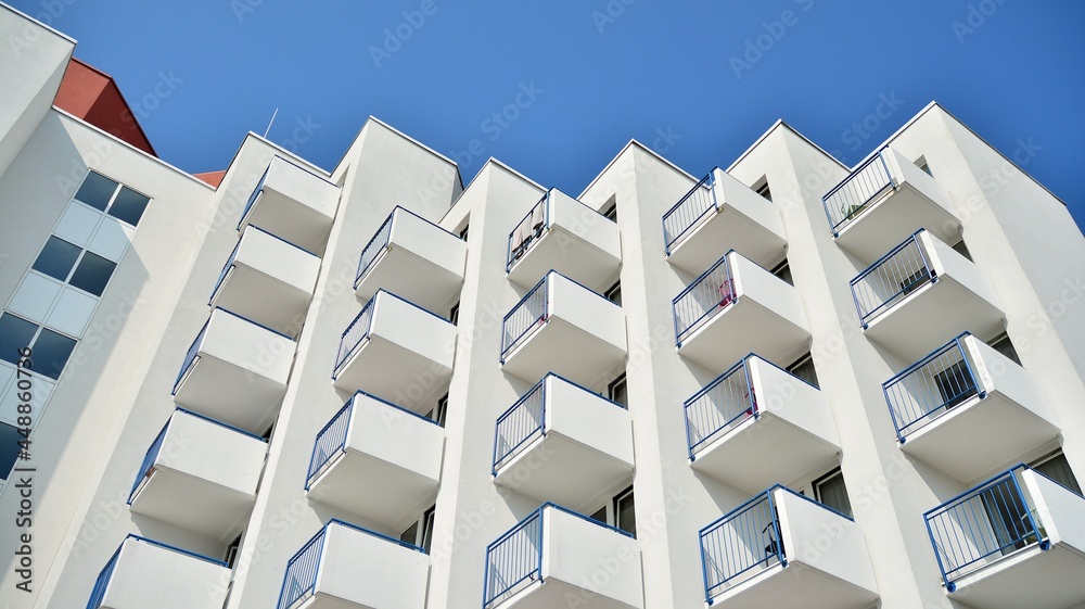 Modern white facade of a residential building with large windows. View ...
