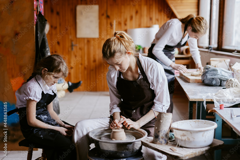 Crafter demonstrating to girl workflow of handicraft Stock Photo ...