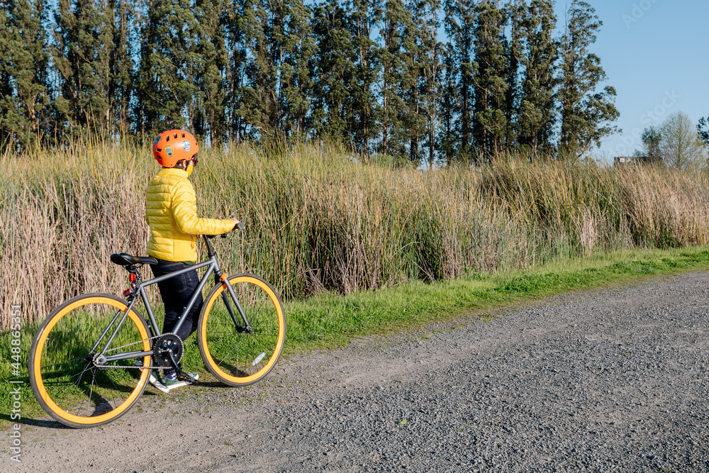 Teen boy walking with bike along road in countryside Stock Photo ...