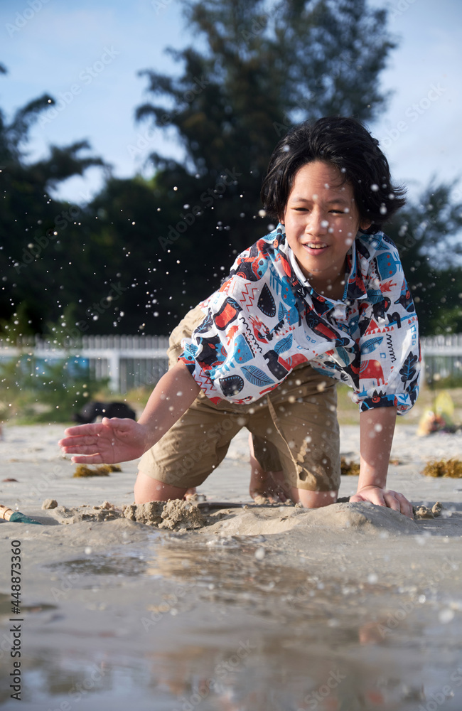 Cute beautiful Asian girl playing sand sculpture on the beach by the ...