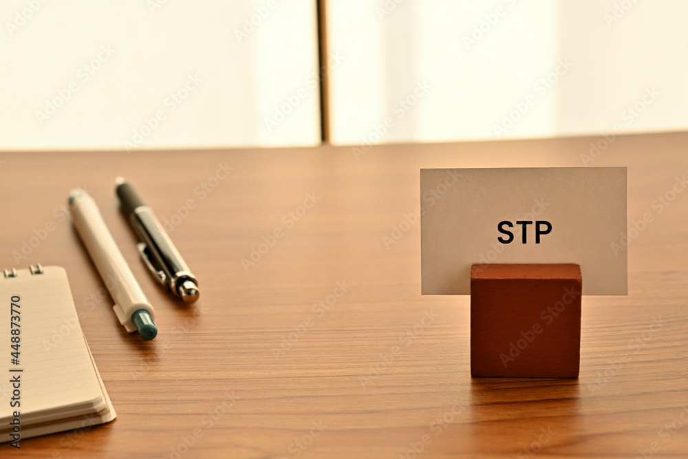 There is a card on paper stand with the word of STP which is an ...