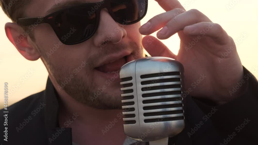 bearded rock star singer with glasses sing expressive song in retro ...