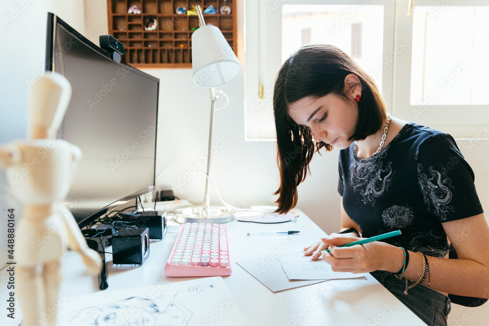 Cute girl drawing at her desk Stock Photo | Adobe Stock