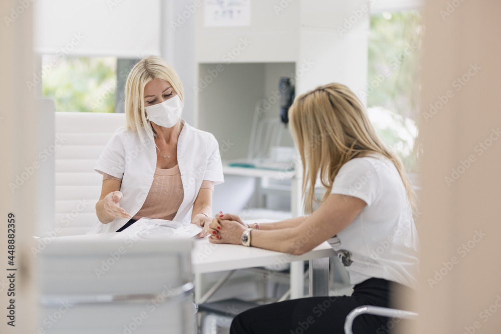 Charming woman doctor giving advice to patient Stock Photo | Adobe Stock