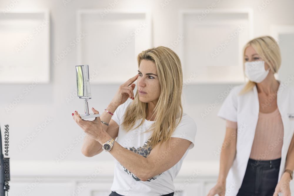 Cosmetologist giving advice to patient Stock Photo | Adobe Stock