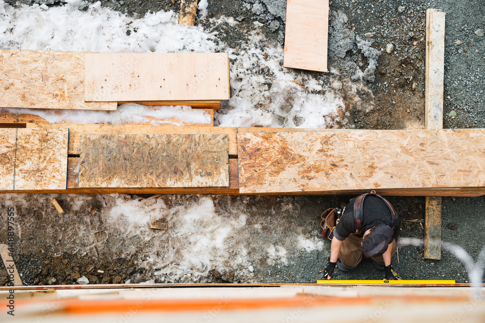 Carpenter working on the job site in winter Stock Photo | Adobe Stock