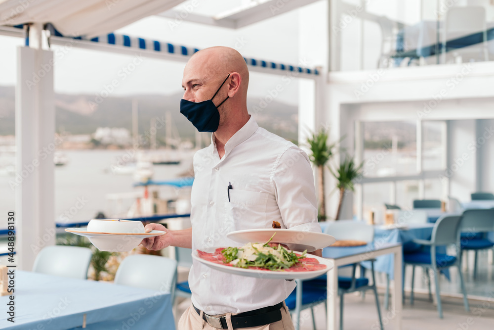 Waiter working at a restaurant Stock Photo | Adobe Stock