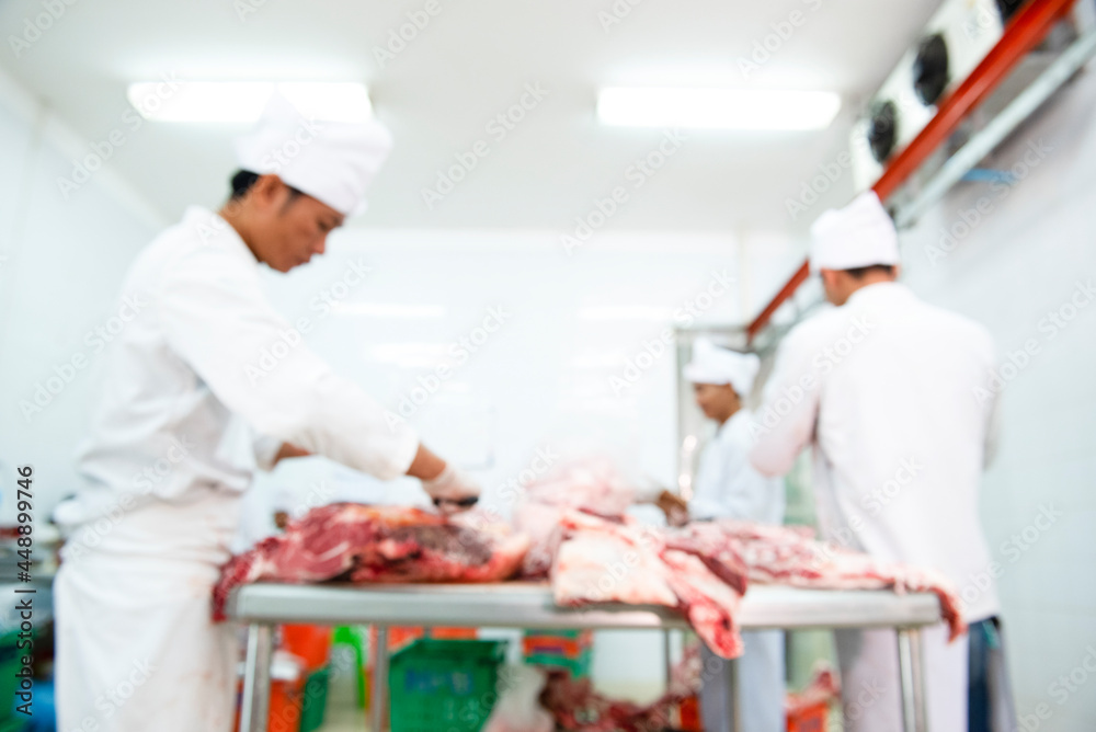Japanese Wagyu Meat Industry A butcher cuts raw meat with a knife at a ...